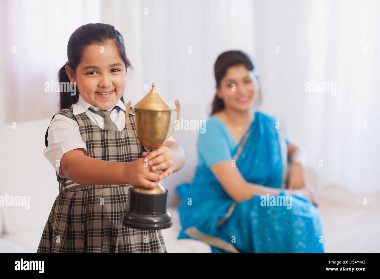 Girl showing winning trophy hi-res stock photography and images - Alamy