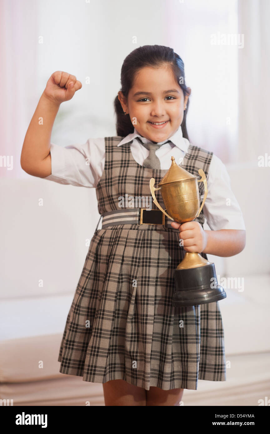 Portrait of a girl holding a trophy and smiling Stock Photo - Alamy