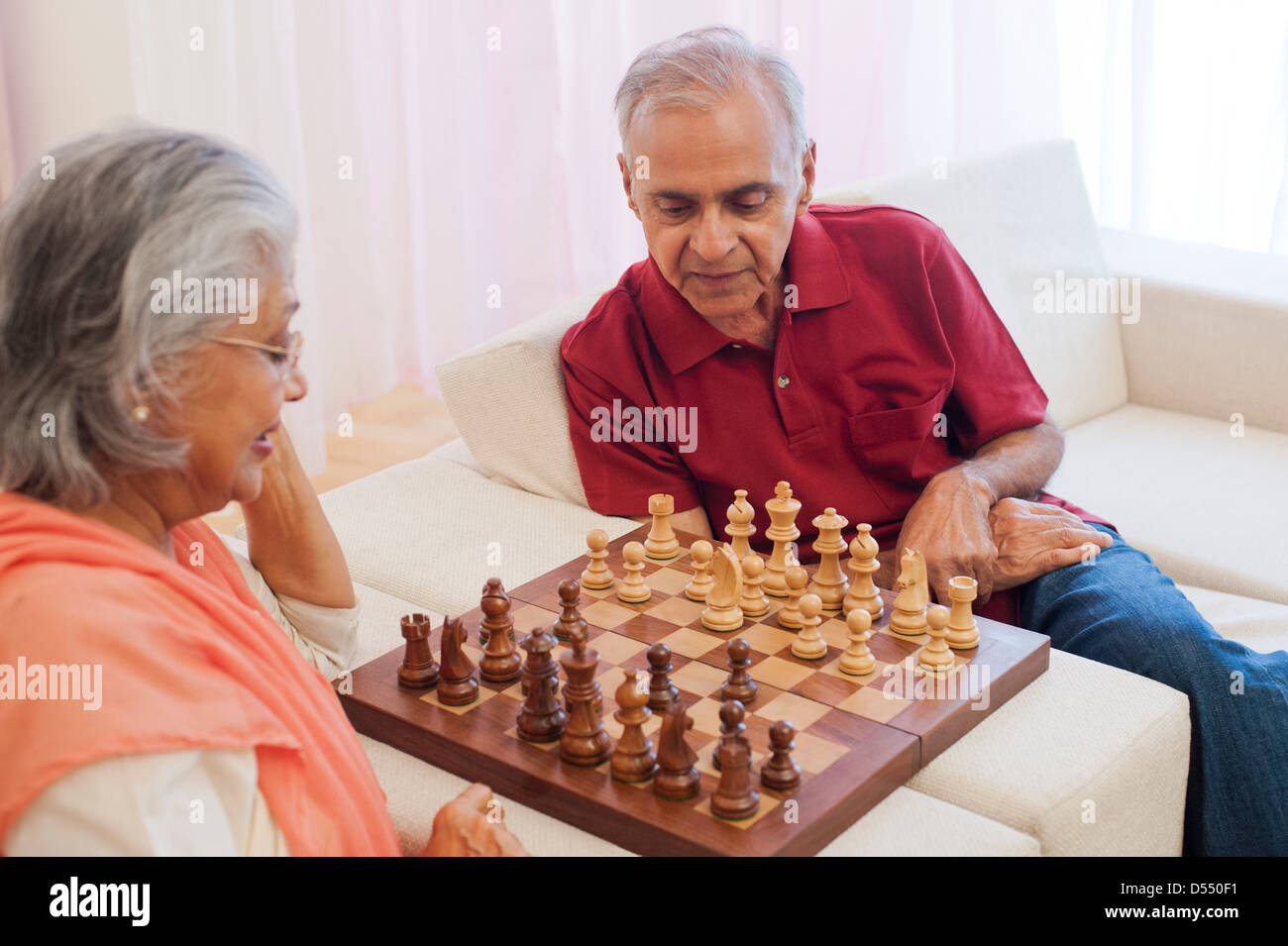 Senior couple playing chess Stock Photo - Alamy
