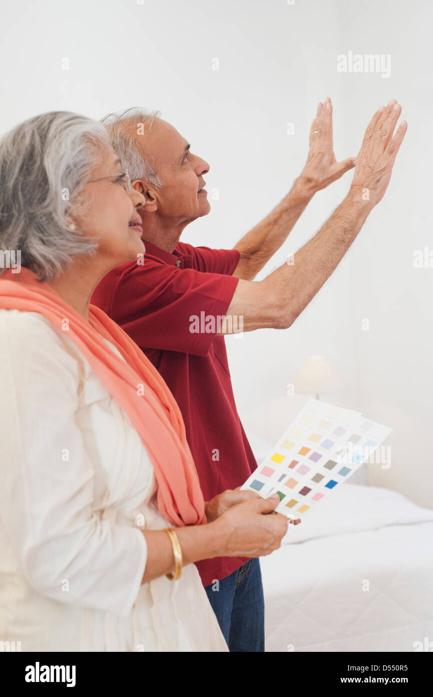 Couple choosing color for their house from a color sample Stock Photo ...