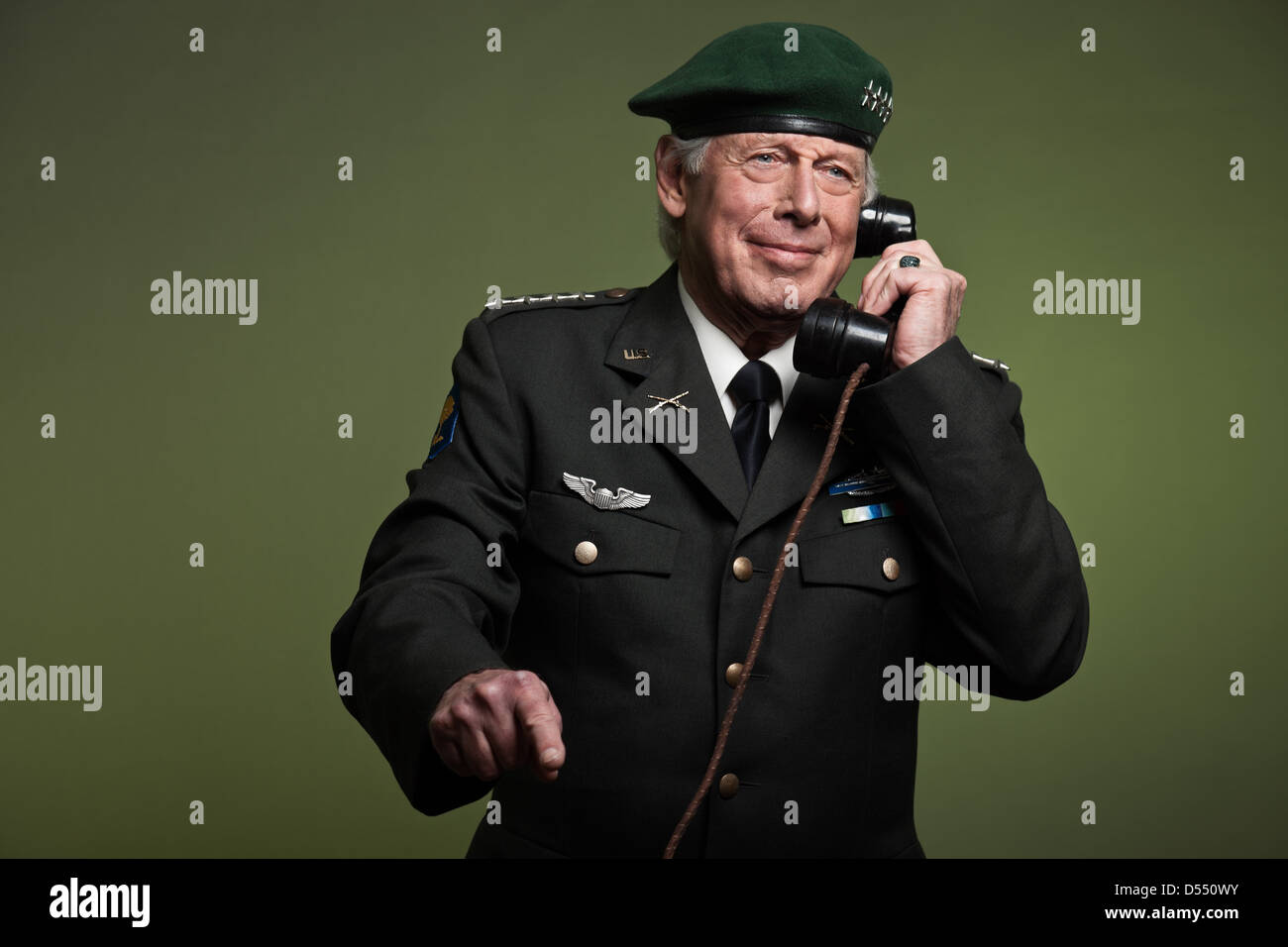 US military general wearing beret. Calling with phone. Studio portrait ...