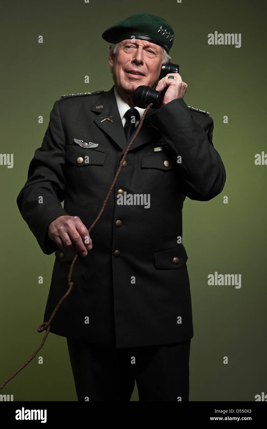 US military general wearing beret. Calling with phone. Studio portrait ...