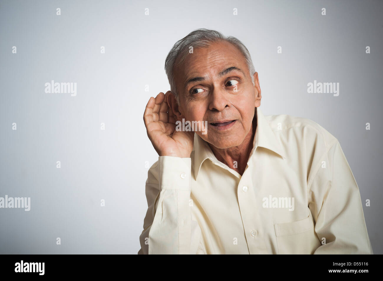 Man cupping hand to ear Stock Photo - Alamy