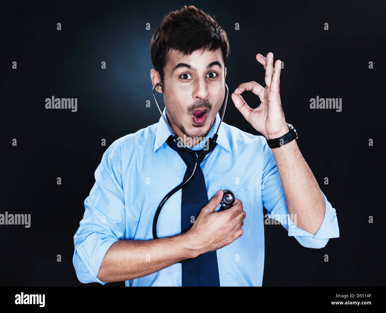 Close-up of a businessman listening to his heartbeat with stethoscope ...