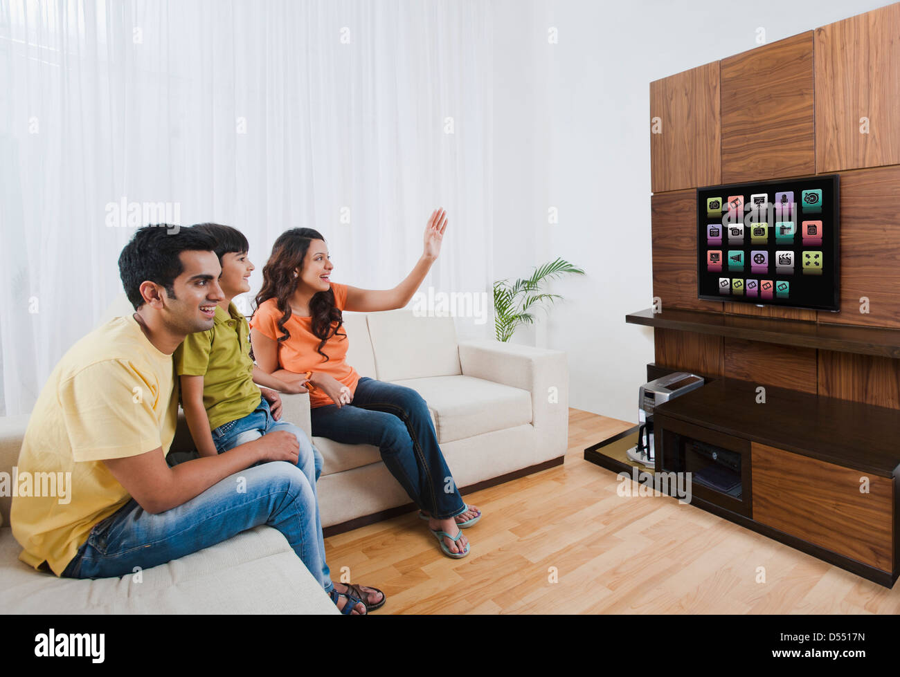Family watching television in a living room Stock Photo - Alamy
