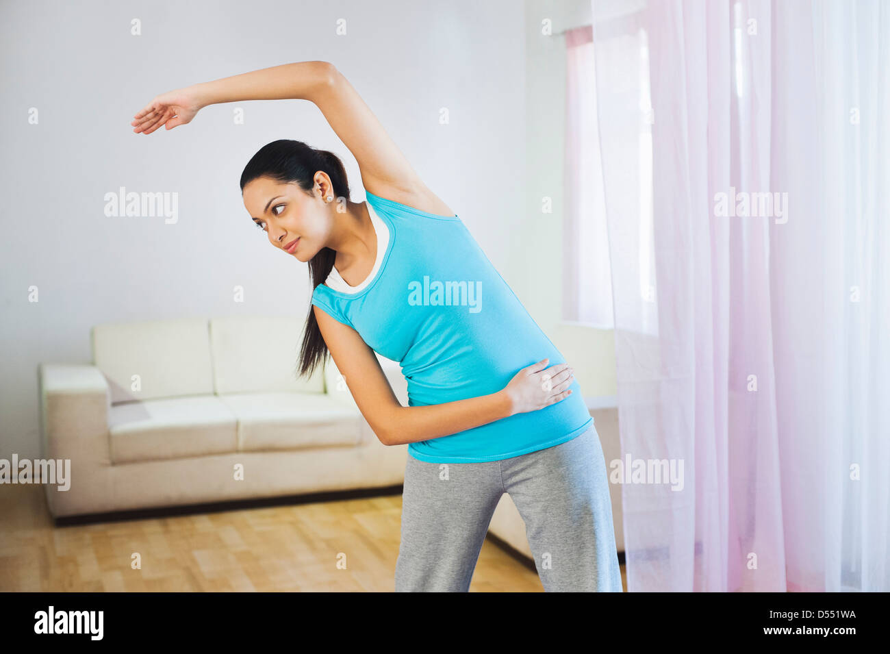 Woman exercising at home Stock Photo - Alamy