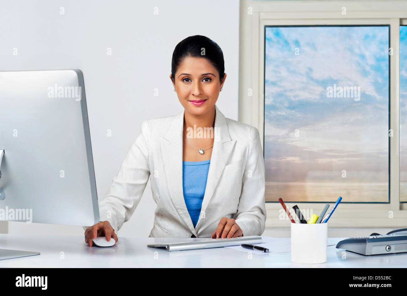 Businesswoman working on a desktop pc Stock Photo - Alamy