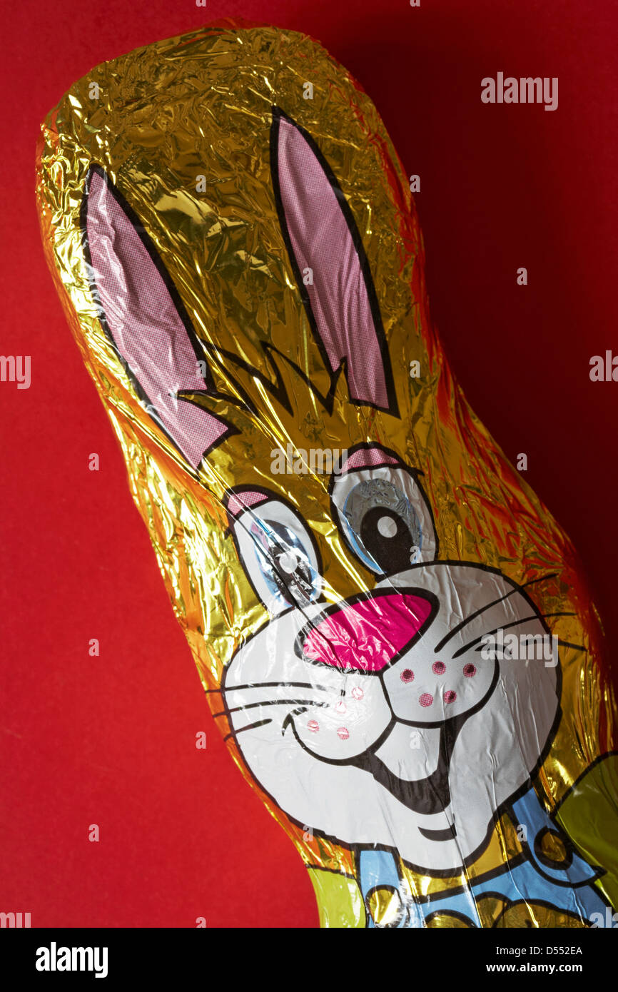 foil wrapped chocolate Easter bunny rabbit set on red background Stock ...