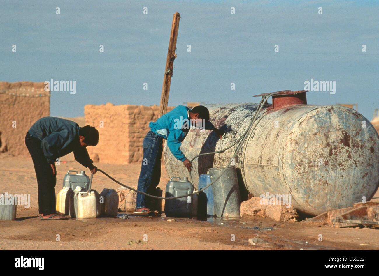 Young men fetch water from tanks in Western Sahara refugee camps ...