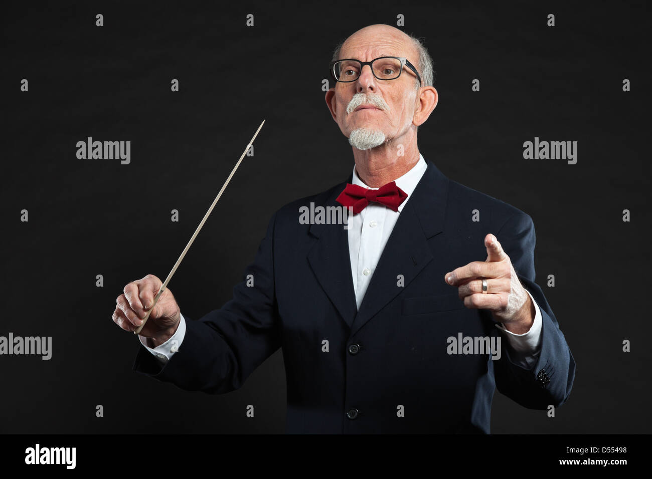 Senior conductor wearing suit. Studio shot Stock Photo - Alamy