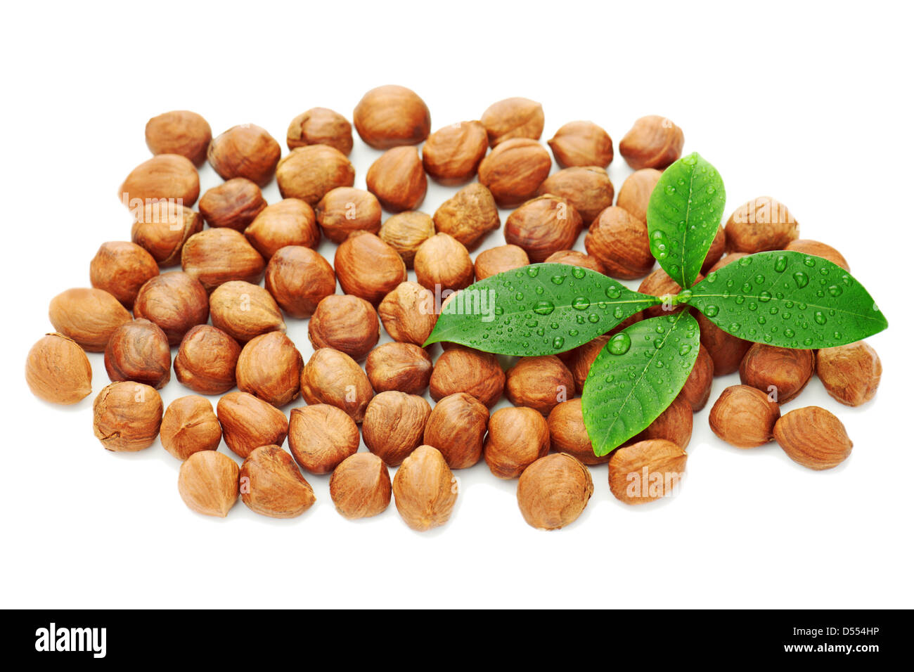 Heap of fresh shelled hazelnuts with green leaves isolated on white ...