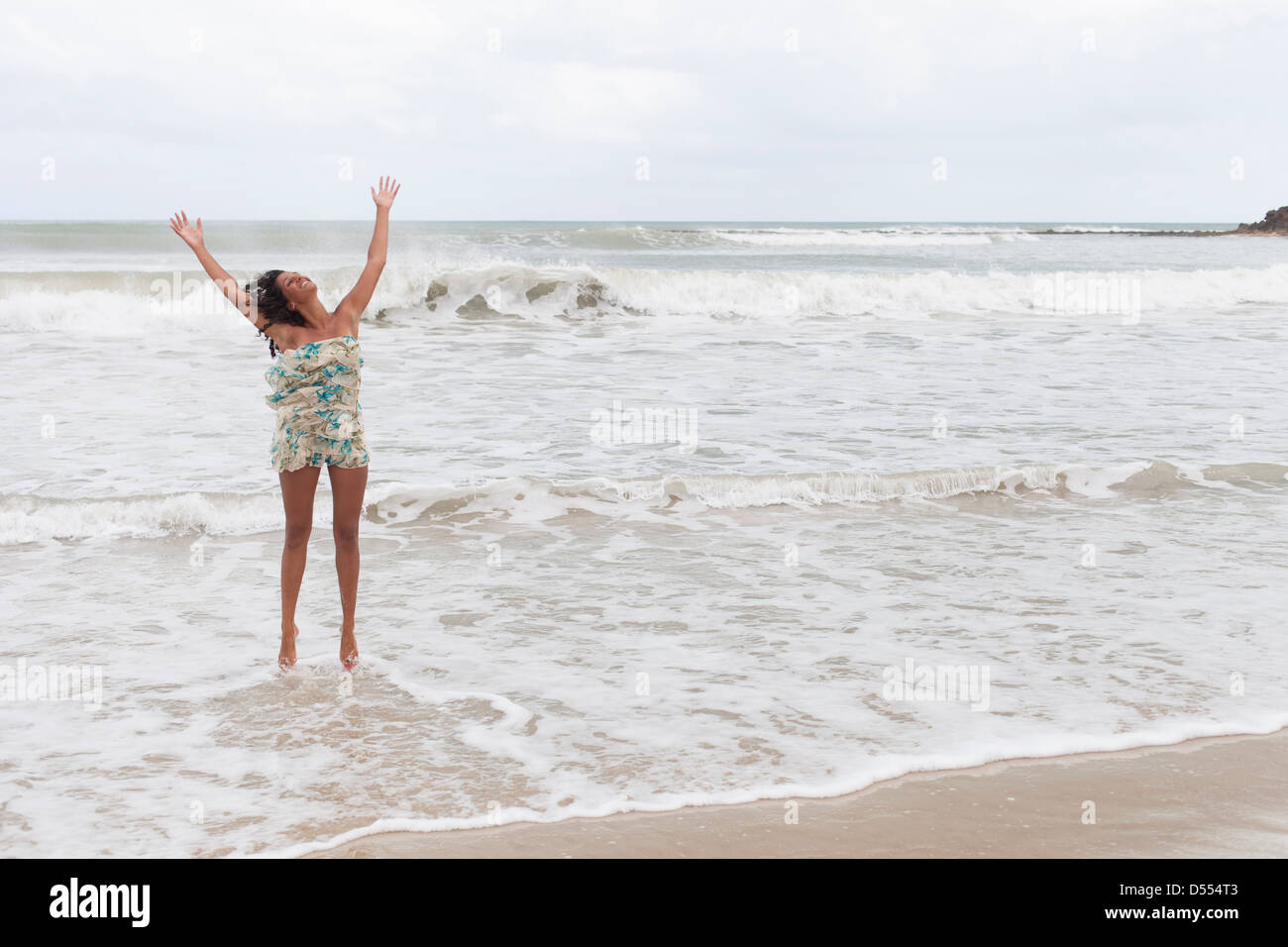 Lady on beach with small waves hi-res stock photography and images - Alamy