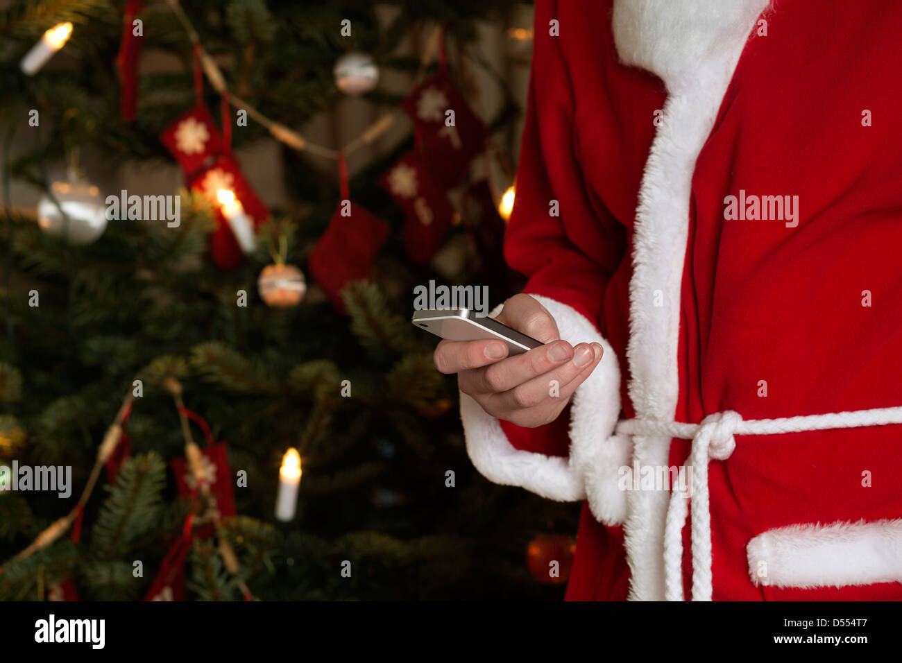 Santa Claus using cell phone Stock Photo - Alamy