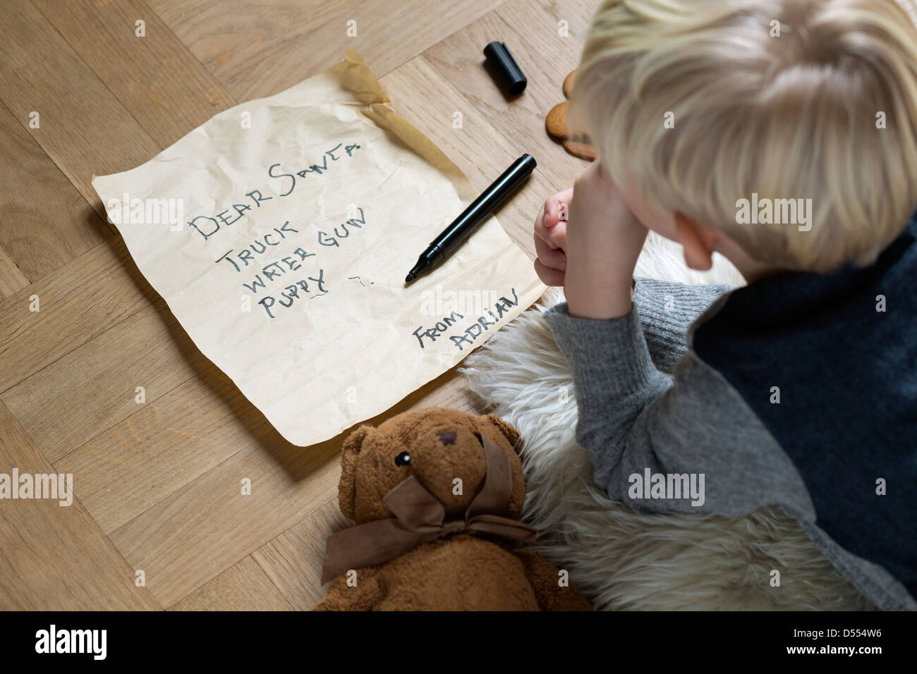 Boy writing Christmas list for Santa Stock Photo - Alamy