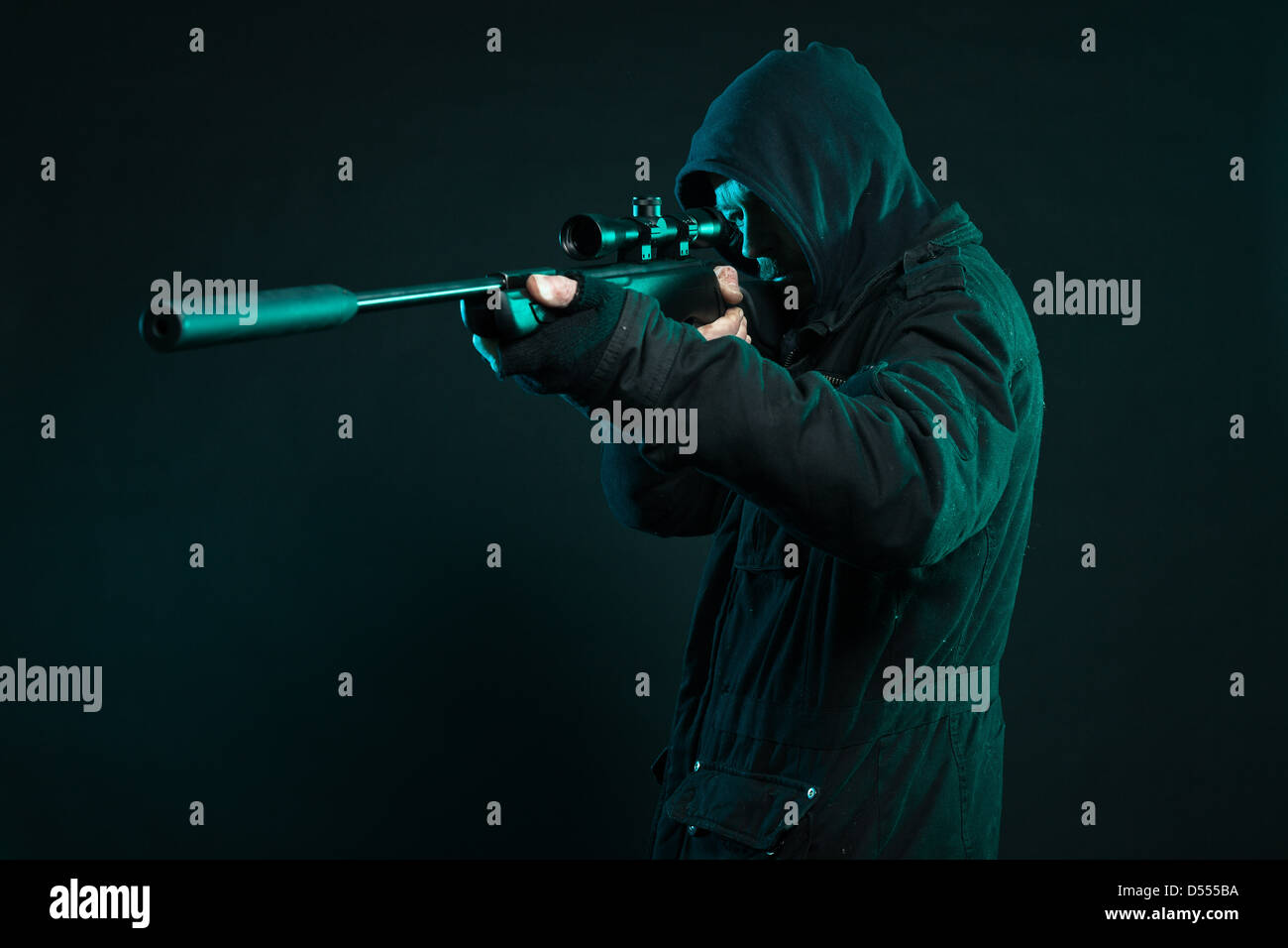 Sniper with beard in black holding gun. Studio shot Stock Photo - Alamy