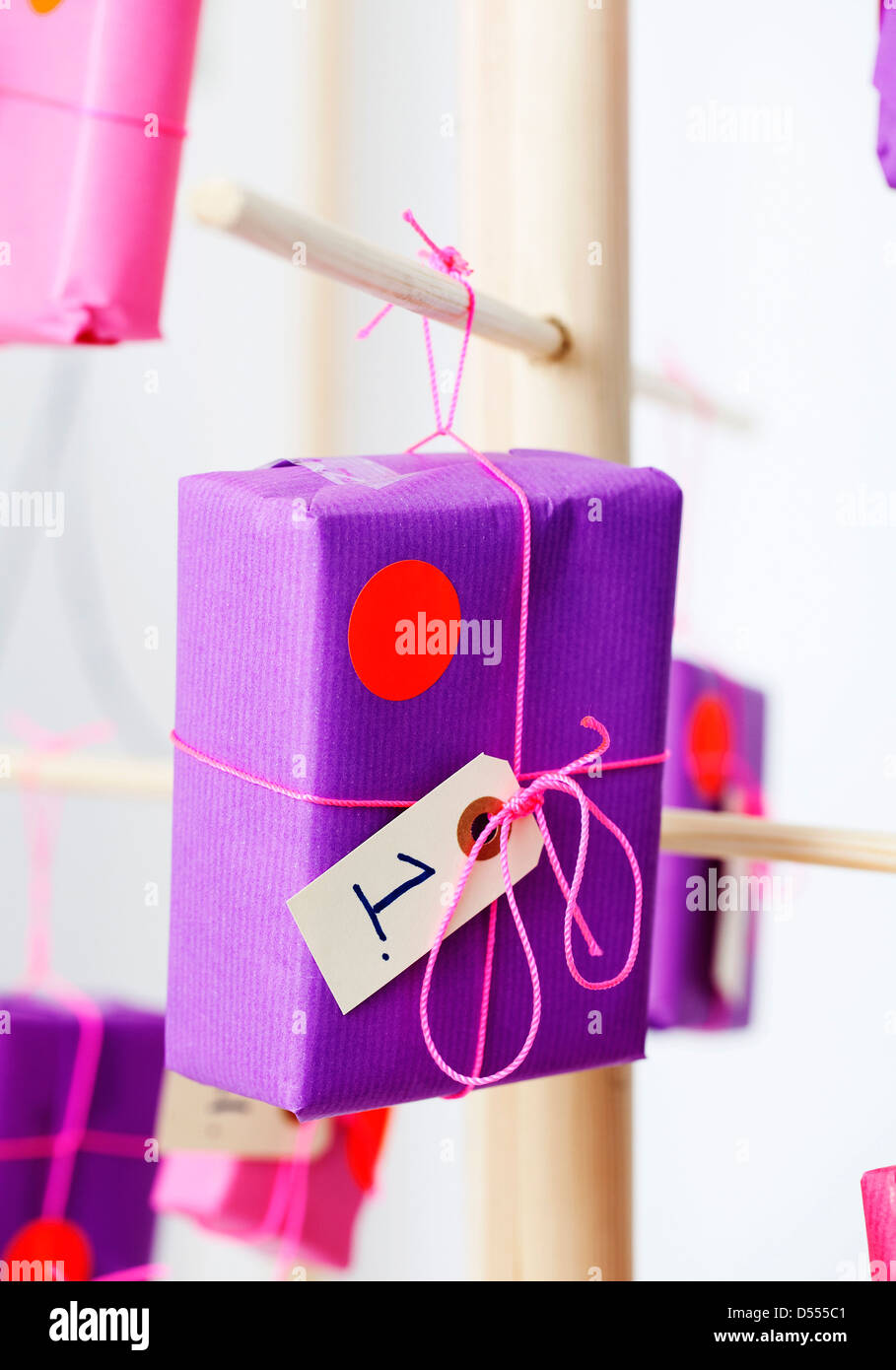 Wrapped gift hanging from hook Stock Photo - Alamy