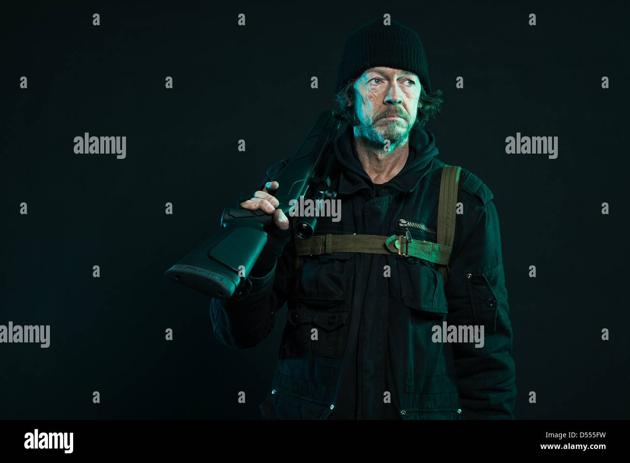 Sniper with beard in black holding gun. Studio shot Stock Photo - Alamy