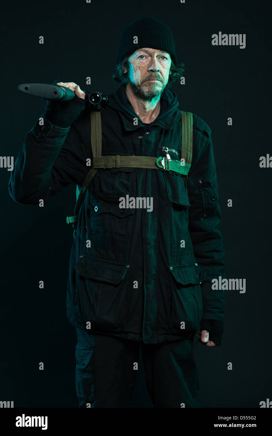 Sniper with beard in black holding gun. Studio shot Stock Photo - Alamy