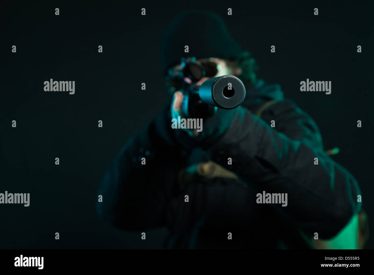 Sniper with beard in black holding gun. Studio shot Stock Photo - Alamy