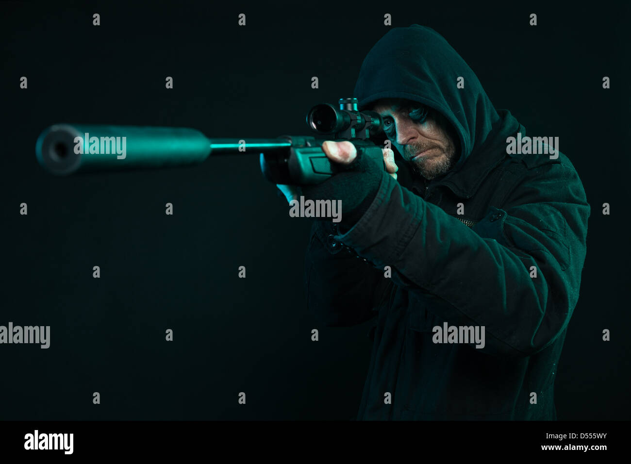 Sniper with beard in black holding gun. Studio shot Stock Photo - Alamy