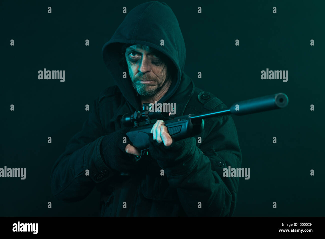Sniper with beard in black holding gun. Studio shot Stock Photo - Alamy