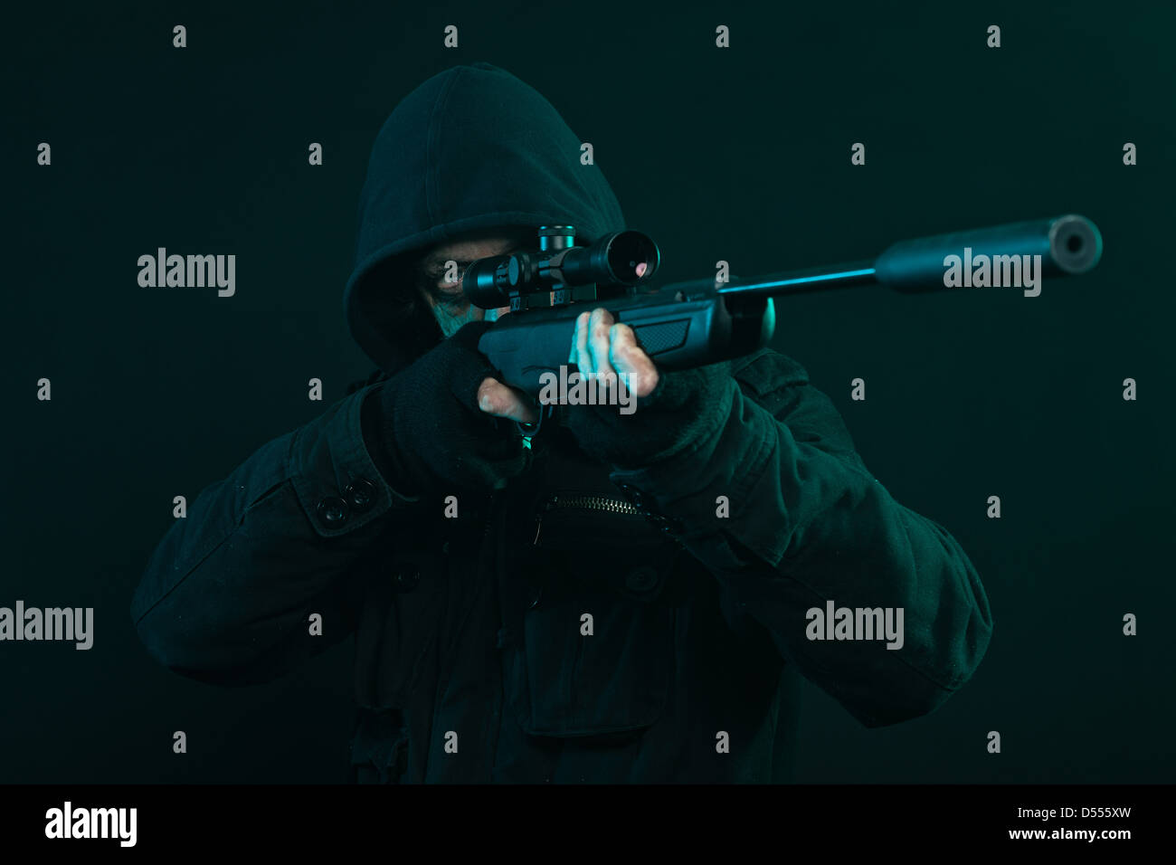 Sniper with beard in black holding gun. Studio shot Stock Photo - Alamy