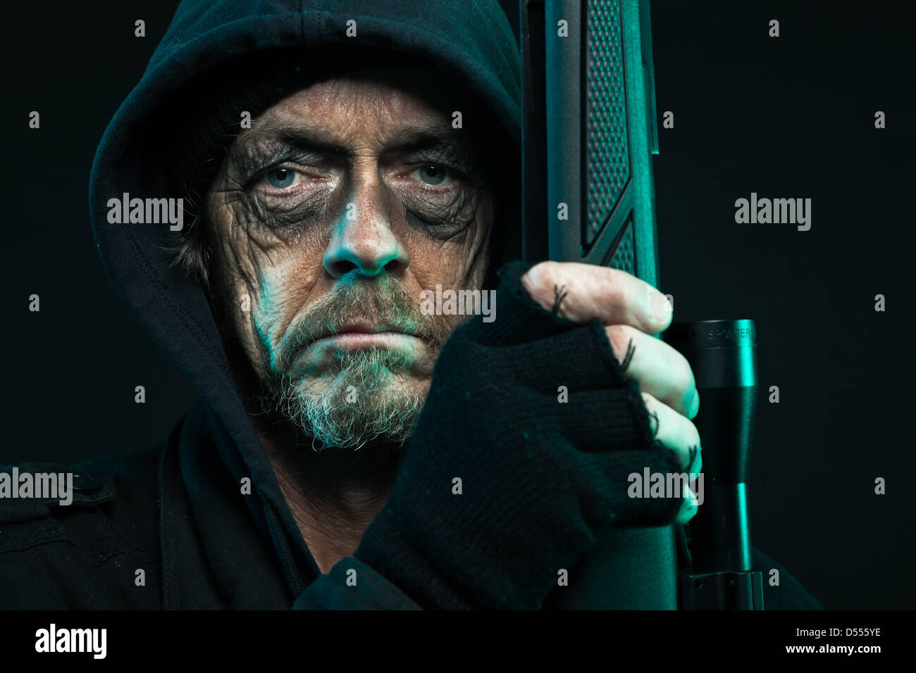 Sniper with beard in black holding gun. Studio shot Stock Photo - Alamy
