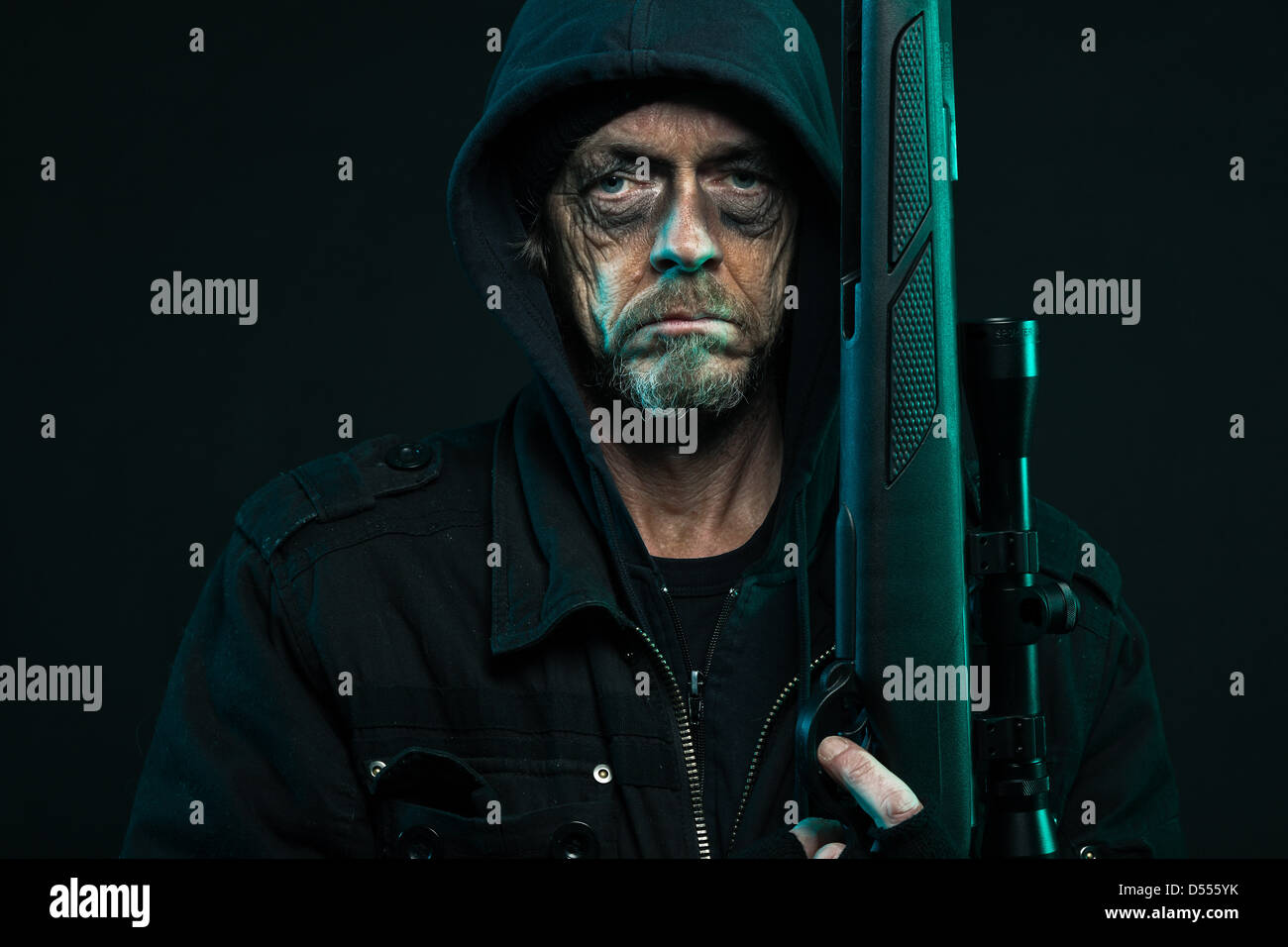 Sniper with beard in black holding gun. Studio shot Stock Photo - Alamy