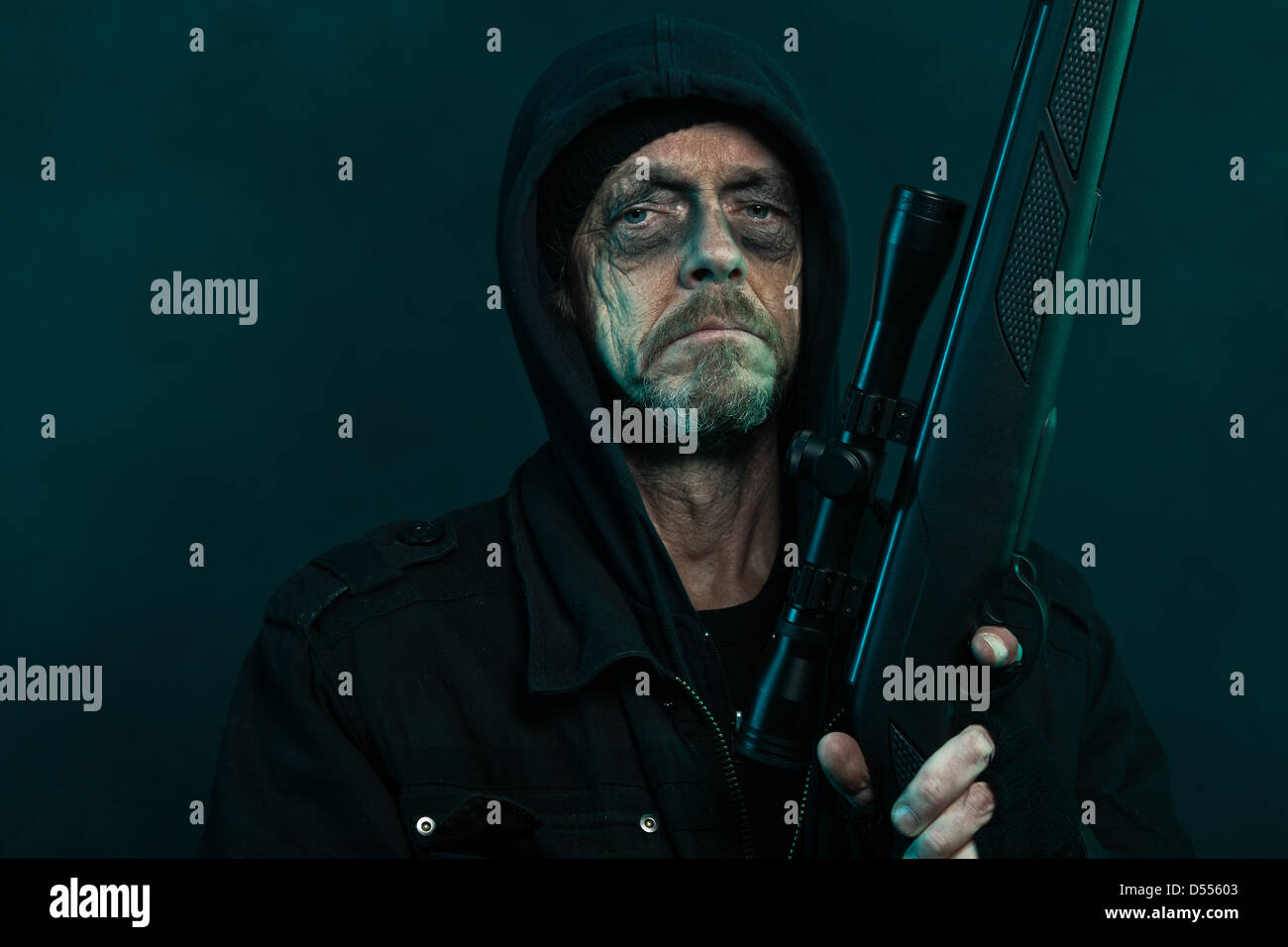 Sniper with beard in black holding gun. Studio shot Stock Photo - Alamy
