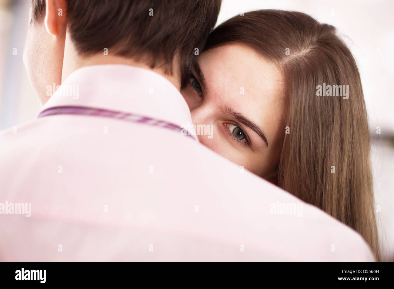 Woman looking over boyfriends shoulder Stock Photo - Alamy