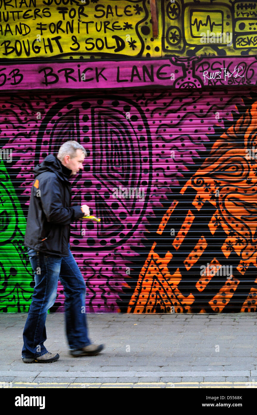 The steel shutter of a shop covered in graffiti, Brick Lane, London, UK ...