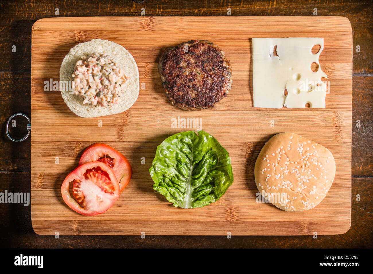 Table with hamburger and condiments Stock Photo - Alamy