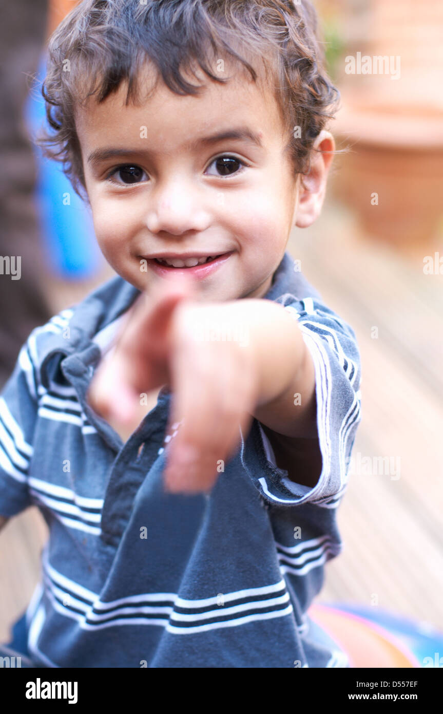 Smiling boy pointing forward Stock Photo - Alamy