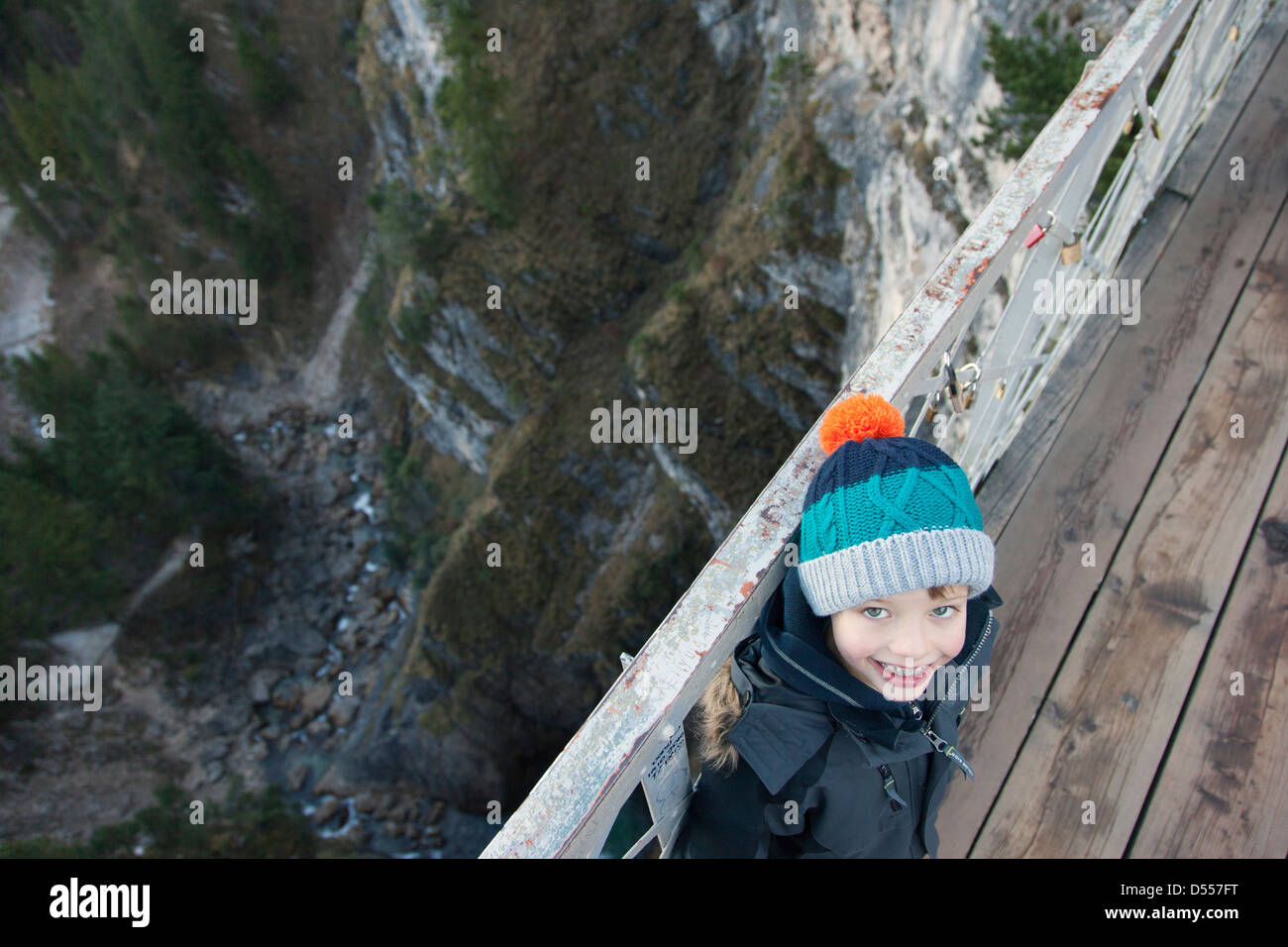 Boy standing on wooden pier Stock Photo - Alamy