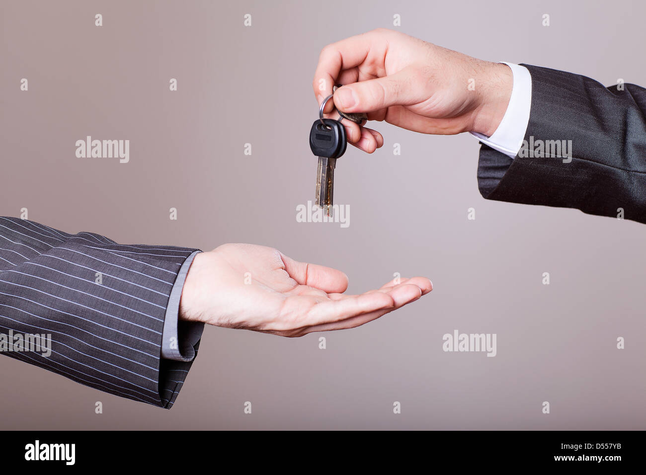 Man s Hand Giving Keys To Another Man Stock Photo Alamy