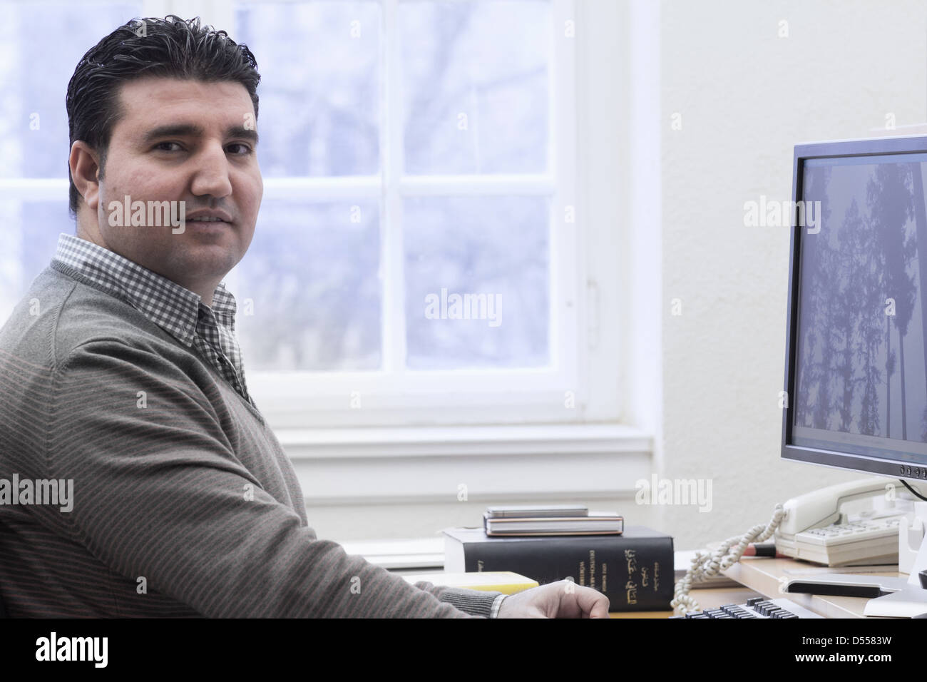 Man working at computer in office Stock Photo - Alamy
