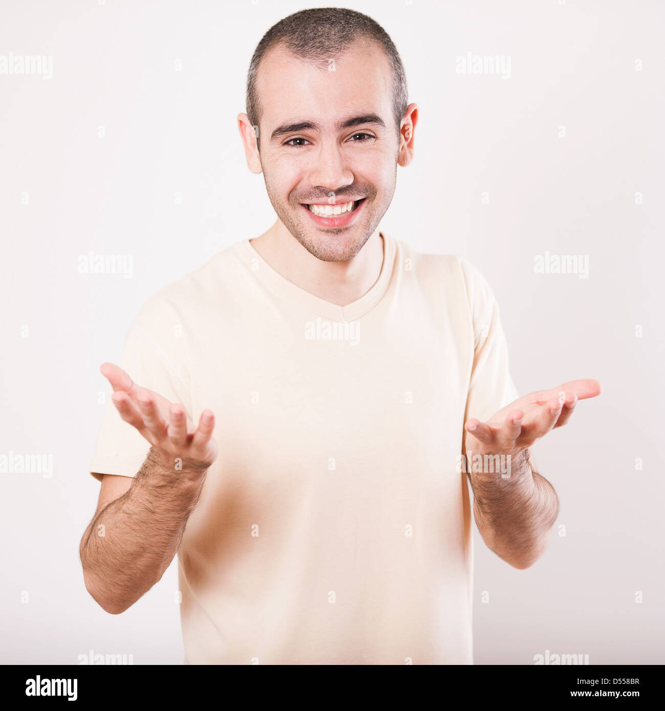 Happy smiling man on shirt presenting and showing something on white ...