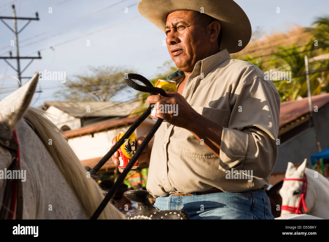 Costa Rican cowboys riding through town during the Tope de Caballos at ...