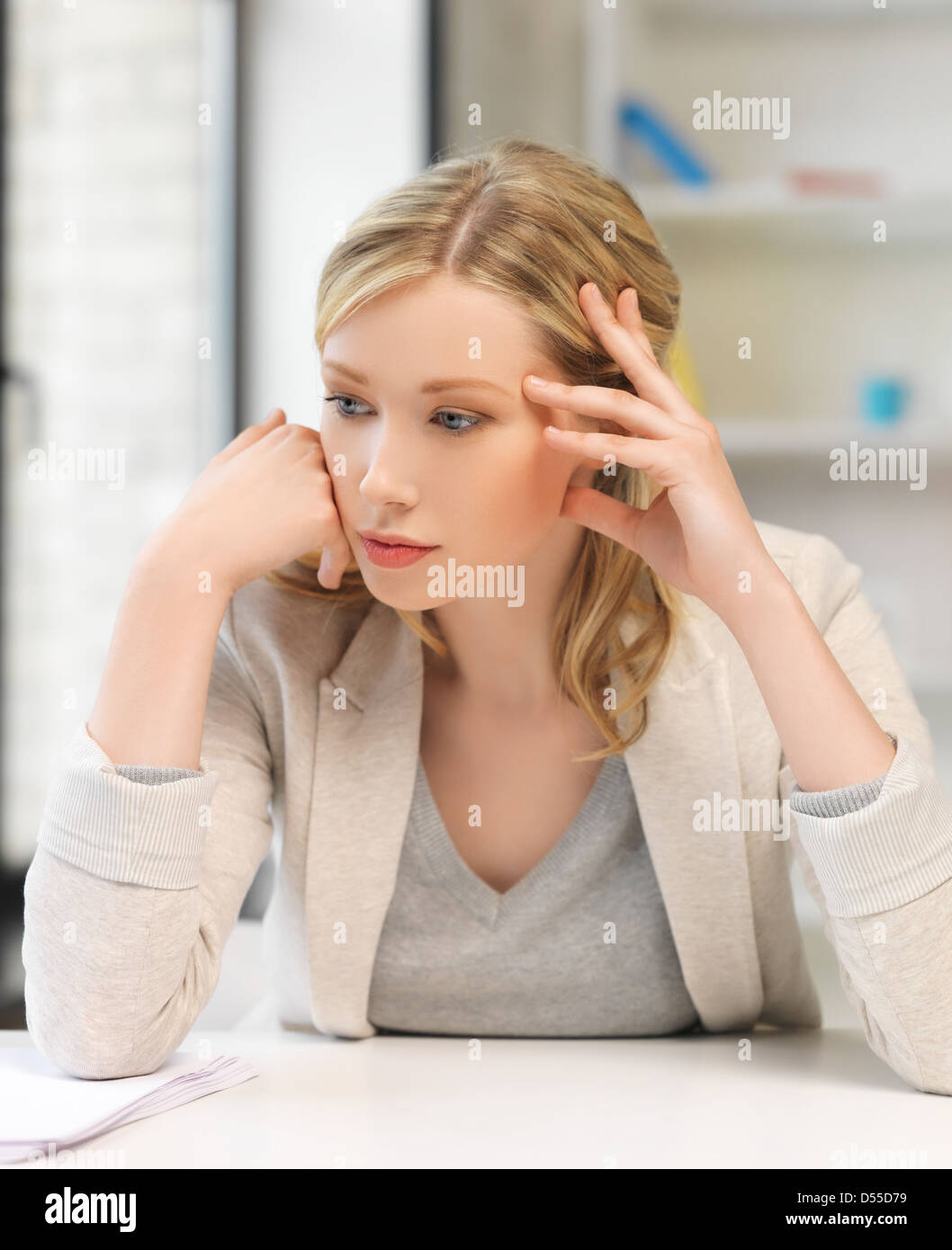bored and tired woman behind the table Stock Photo - Alamy