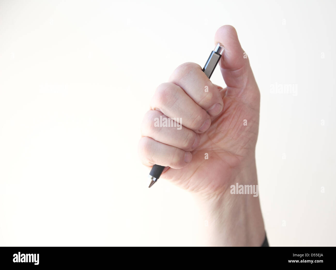 a man grasps a ballpoint pen in his hand Stock Photo - Alamy