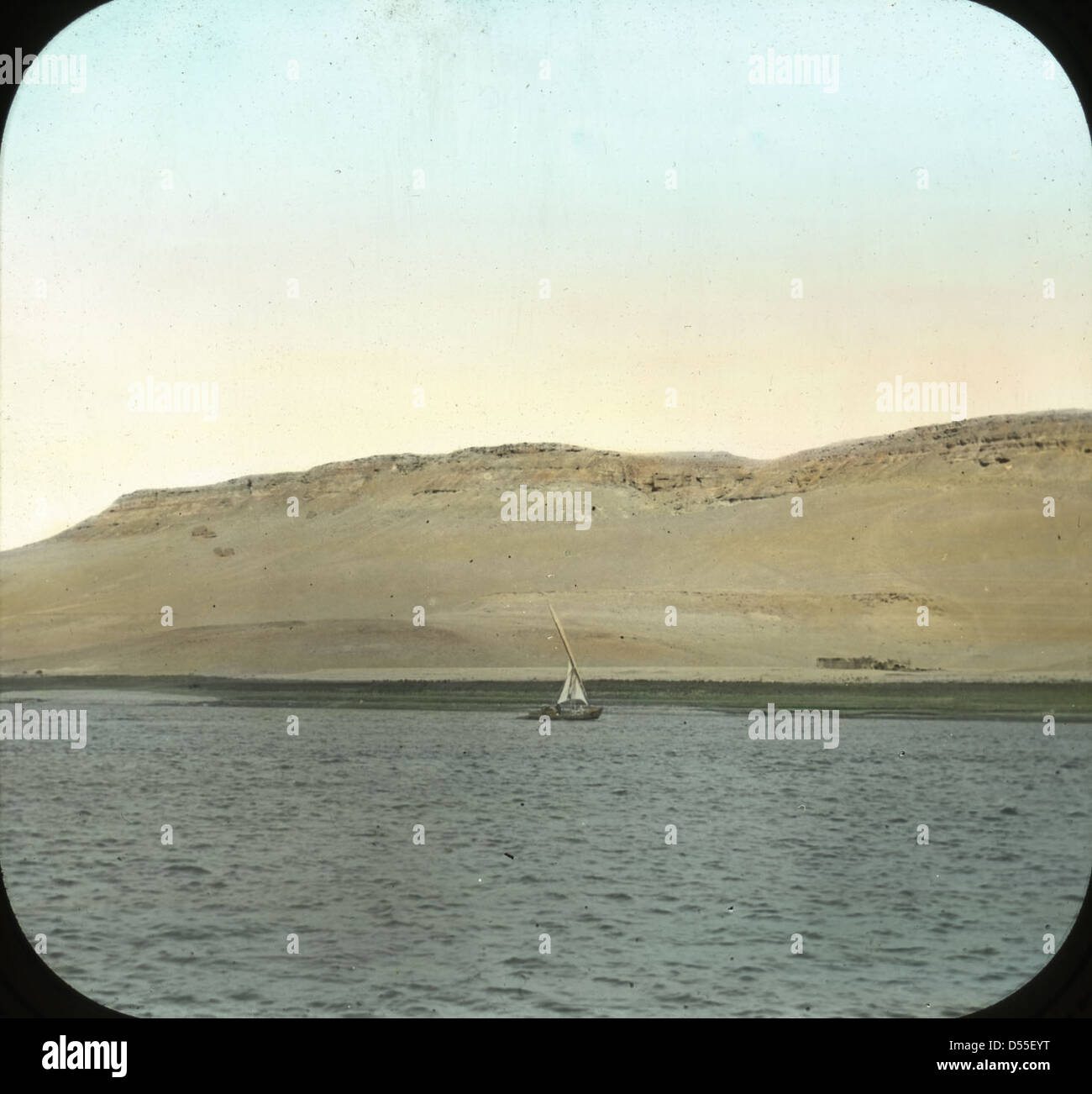 A boat navigating the Nile River near Assiut, Egypt, captured in a ...