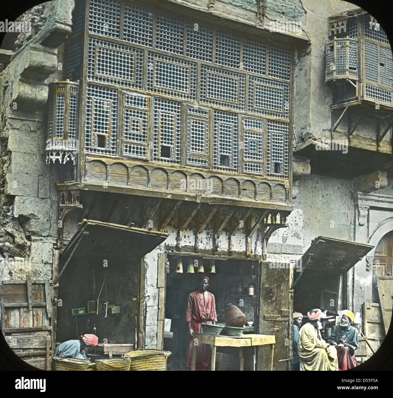 A traditional Arabic window overlooks a busy native bazaar in Cairo ...