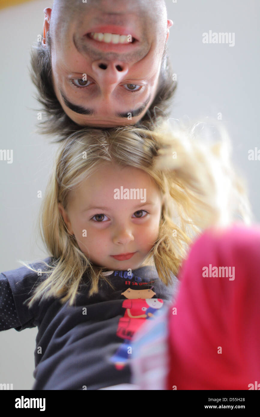 Handewitt, Germany, a girl and his father put their heads Stock Photo ...