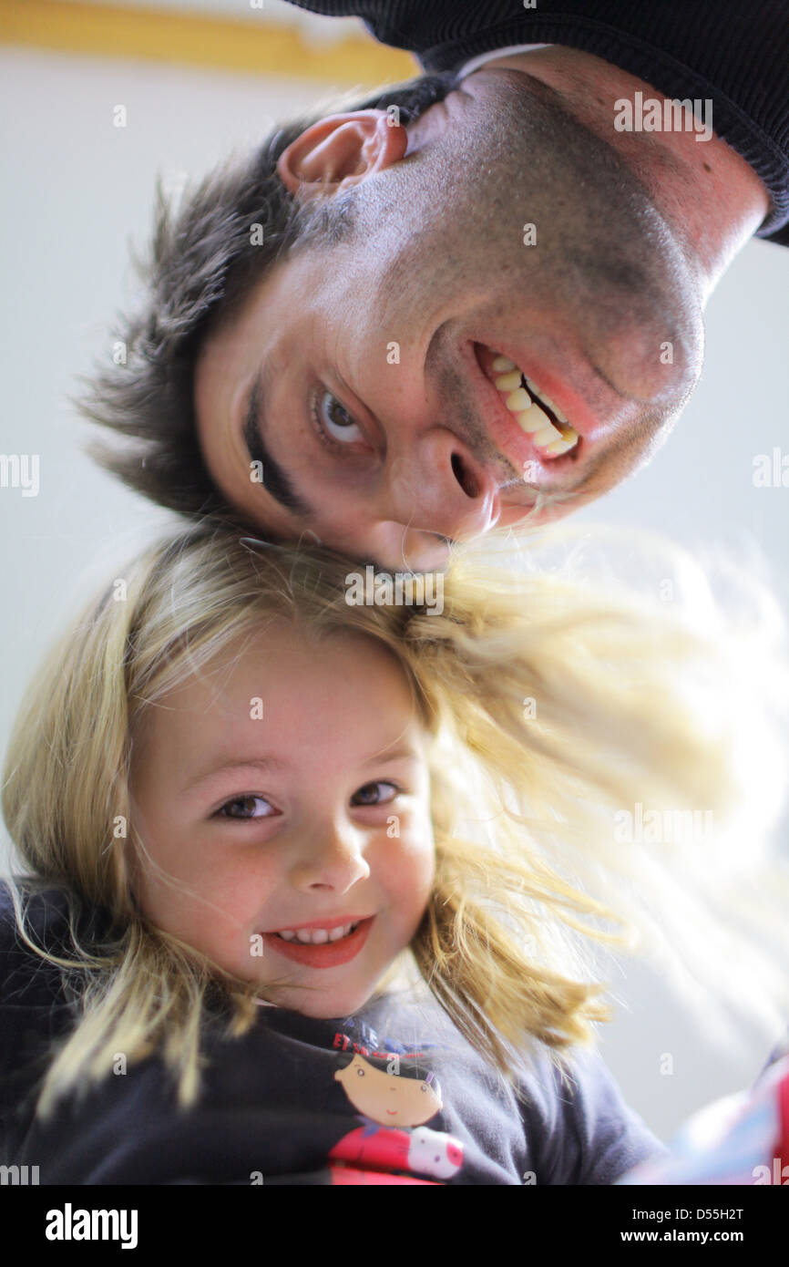 Handewitt, Germany, a girl and his father put their heads Stock Photo ...