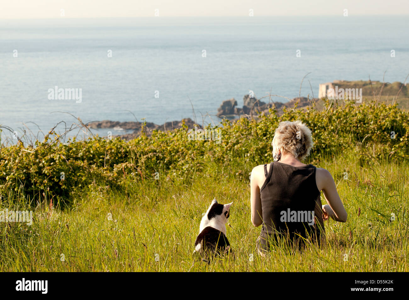 girl with her cat looking at sea Stock Photo - Alamy