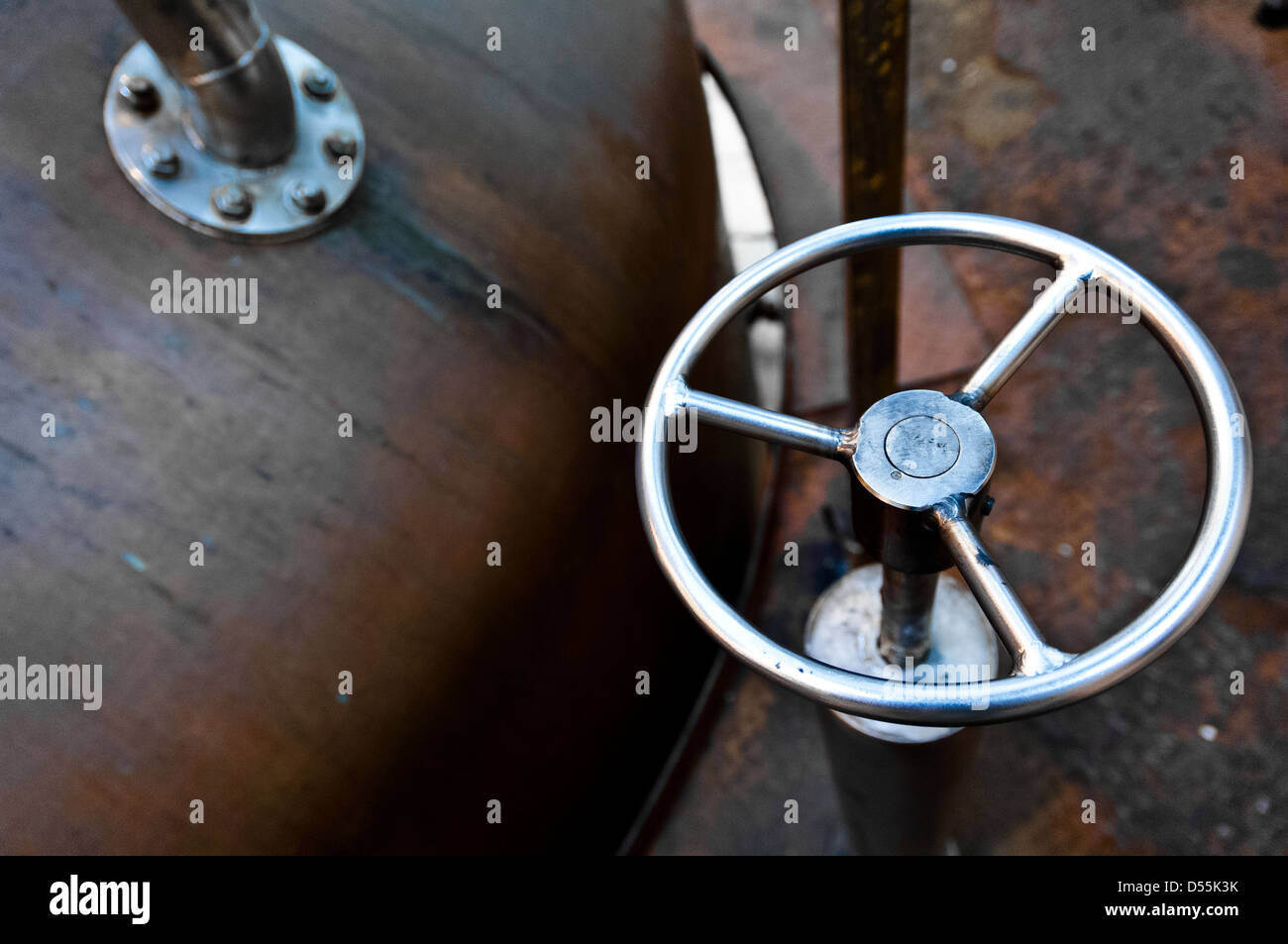 Stainless steel wheel valve standing beside vat at distillery Stock ...