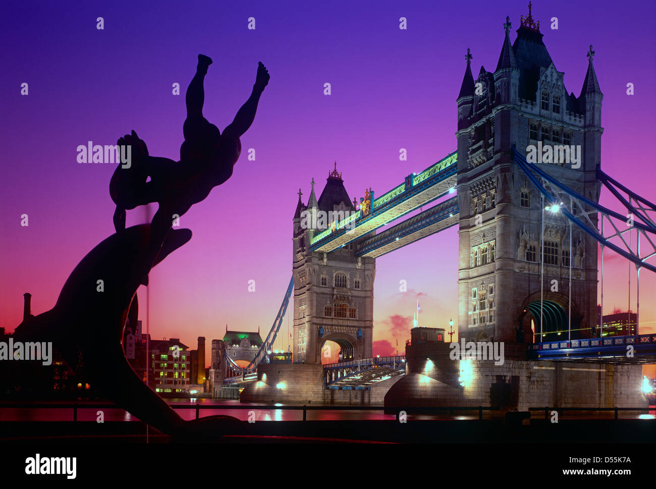 Tower Bridge at dusk with Dolphin and Mermaid statue, London Stock ...