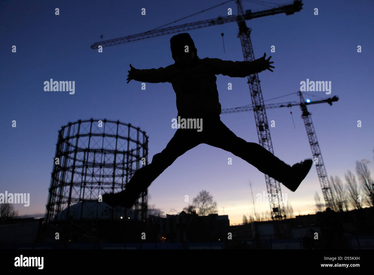 Berlin, Germany, Silhouette, Boy makes a leap into the air in front of ...