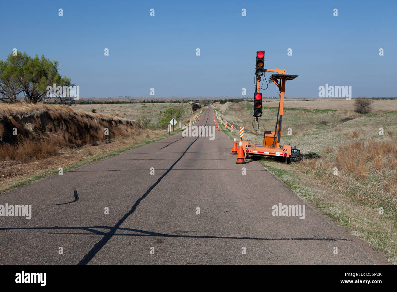 Automatic traffic regulator at the side of t he road showing red lights ...