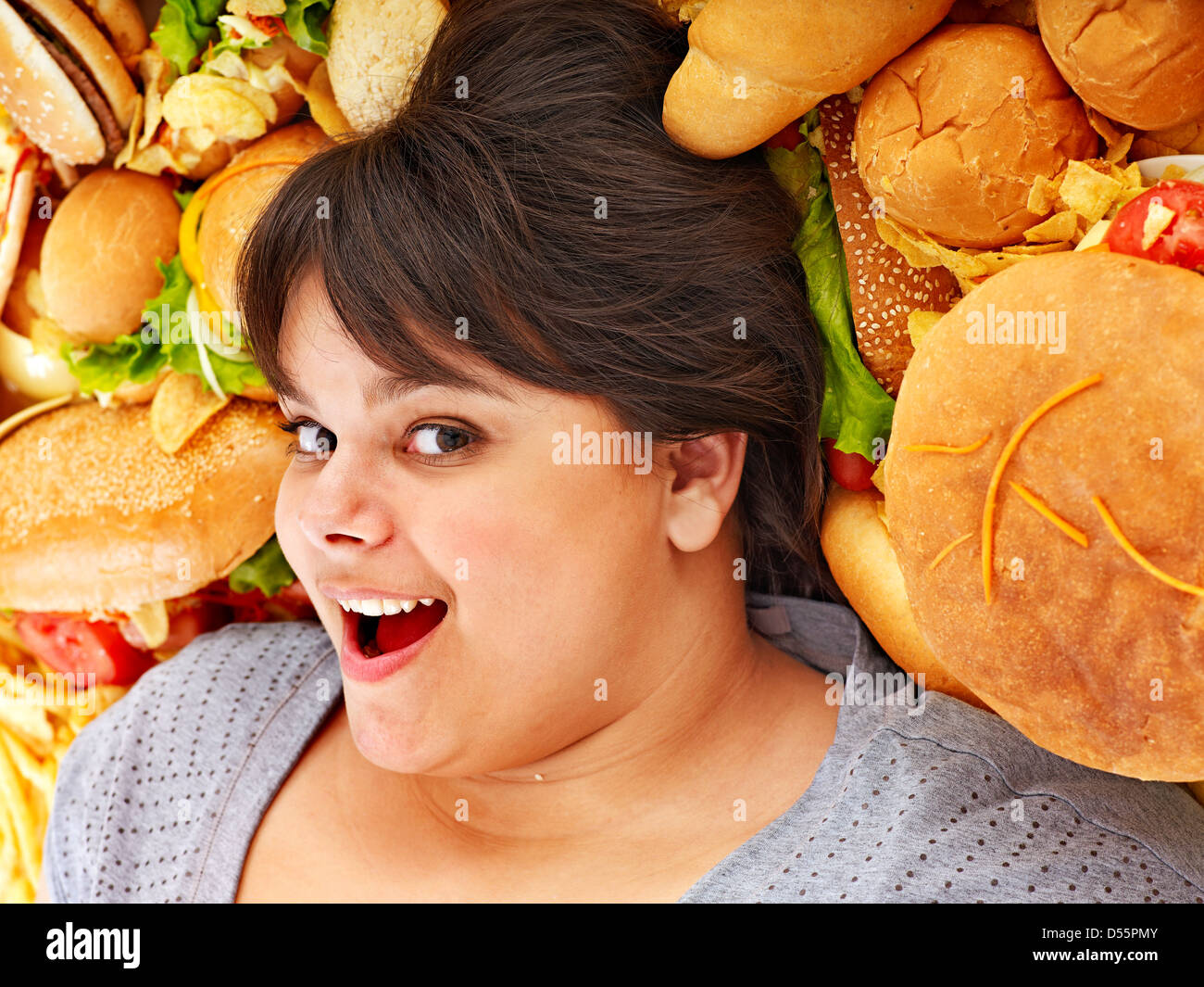 Overweight woman with fast food Stock Photo - Alamy